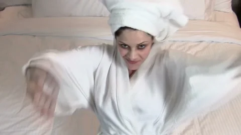 Woman falls backwards onto bed V1 - HD | Stock Video | Pond5