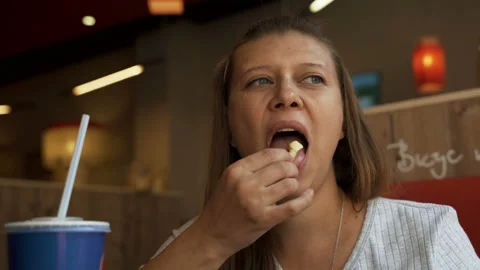 Woman In Fast Food Cafe Eating Junk Food | Stock Video | Pond5
