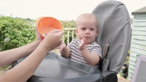 Woman feeding Tired child with spoon. Mo... | Stock Video | Pond5