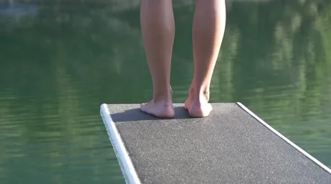 Woman feet on springboard in front of a ... | Stock Video | Pond5