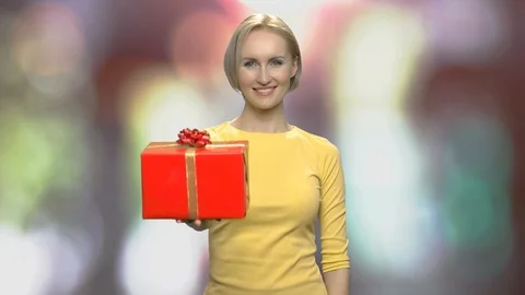 Woman with festive gift box on blurred b... | Stock Video | Pond5