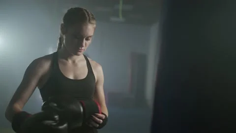 Woman fighter pods boxing gloves on his ... | Stock Video | Pond5