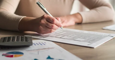 Woman filling and signing tax form | Stock Video | Pond5