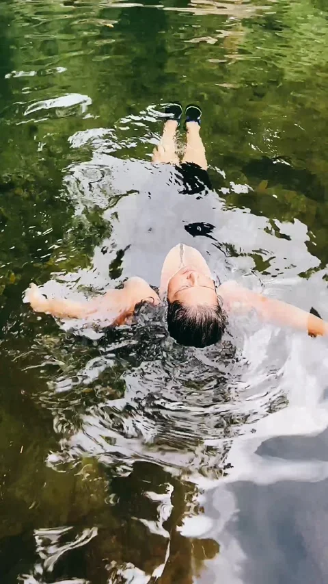 Woman floating, Woman floating in natura... | Stock Video | Pond5