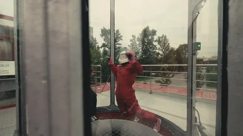 Woman flying in wind tunnel. Indoor skyd... | Stock Video | Pond5