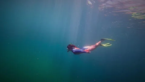 Woman freediver with fins dive to sea bo... | Stock Video | Pond5