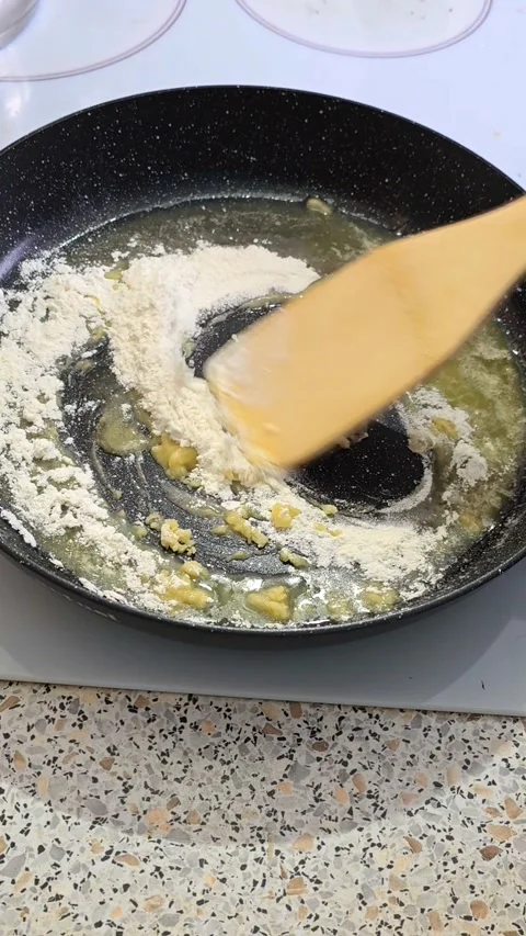 A woman is frying flour in oil in a hot ... | Stock Video | Pond5