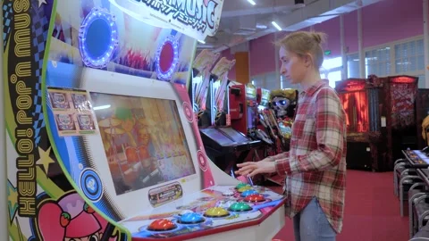 Woman gamer playing Japanese arcade rhyt... | Stock Video | Pond5