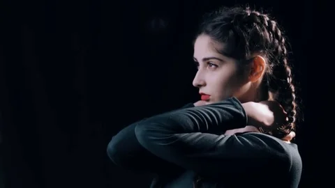 Woman gracefully moving on black backgro... | Stock Video | Pond5