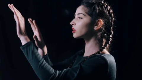 Woman gracefully moving on black backgro... | Stock Video | Pond5