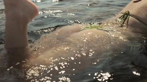 Woman in green bikini floating with body... | Stock Video | Pond5