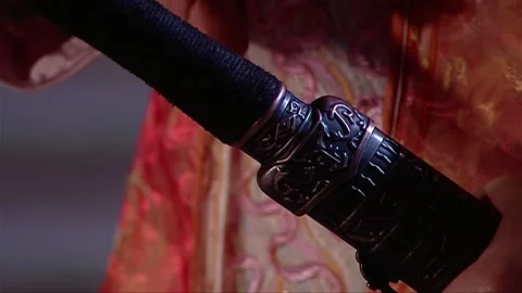 The woman grips the sword handle, ready ... | Stock Video | Pond5