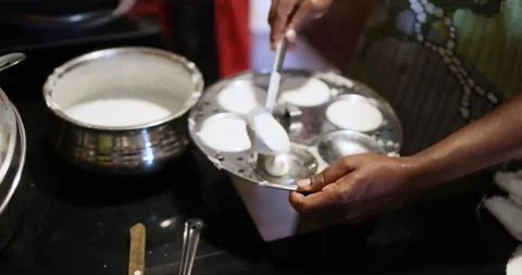 a woman hand cooking Idlis Popular South... | Stock Video | Pond5