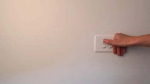 Woman hand turning on two white light sw... | Stock Video | Pond5