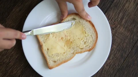 Woman hands spreading butter on toast. T... | Stock Video | Pond5