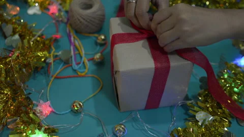 Woman hands untie red ribbon at gift box... | Stock Video | Pond5