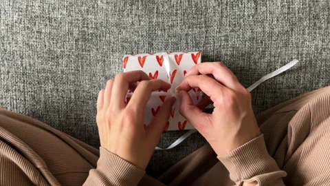 Woman hands untie white ribbon on gift b... | Stock Video | Pond5