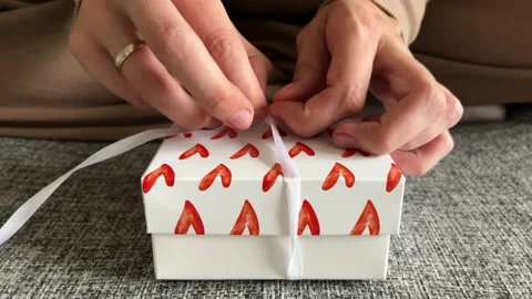 Woman hands untie white ribbon on gift b... | Stock Video | Pond5