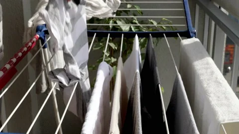 Woman hanging wet clean cloth on laundry... | Stock Video | Pond5
