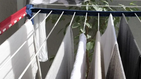 Woman hanging wet clean cloth on laundry... | Stock Video | Pond5