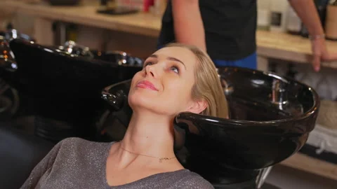 Woman with head leaning back into sink w... | Stock Video | Pond5