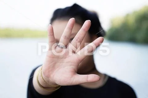 Woman hiding face behind hand woman hiding face behind hand. defense ...