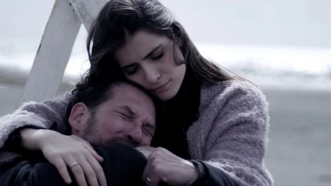 Woman holding tight crying desperate man | Stock Video | Pond5