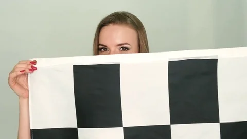 Woman is holding a waving race checkerd ... | Stock Video | Pond5