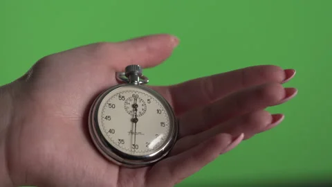 A Woman Holds Stopwatch On The Green Scr... | Stock Video | Pond5