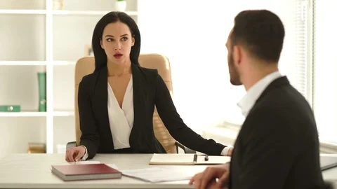 The woman interviews a man at the office... | Stock Video | Pond5