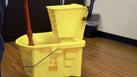Woman janitor using a mop bucket and mop... | Stock Video | Pond5