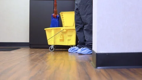 Woman janitor using a mop bucket and mop... | Stock Video | Pond5