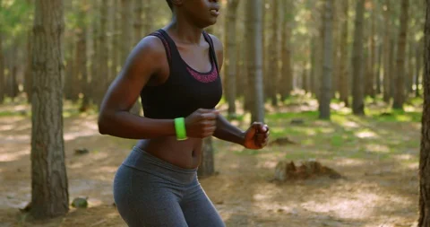 Woman jogging in the forest 4k | Stock Video | Pond5