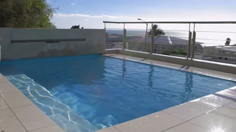 Woman jumping into pool fully clothed | Stock Video | Pond5