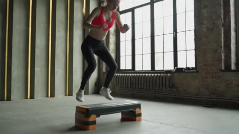 Woman jumping on step platform slow moti... | Stock Video | Pond5
