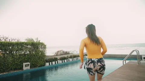 Woman jumping in swimming pool | Stock Video | Pond5