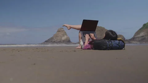 Woman Laying on Beach While Typing on La... | Stock Video | Pond5