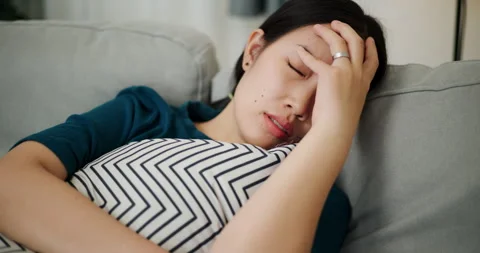 Woman leaned back on the sofa and hugged... | Stock Video | Pond5