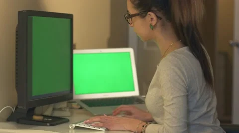 woman leans into dual computer monitors ... | Stock Video | Pond5