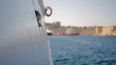 Woman looking out of ship window | Stock Video | Pond5