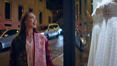 Woman looking wedding showcase at night ... | Stock Video | Pond5