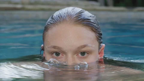 Woman looks at the camera while submergi... | Stock Video | Pond5