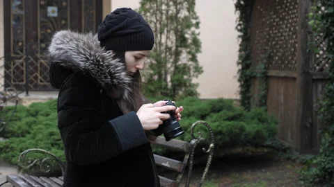 Woman looks at photo on screen of camera... | Stock Video | Pond5