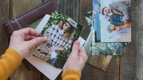Woman looks at printed photos for family... | Stock Video | Pond5