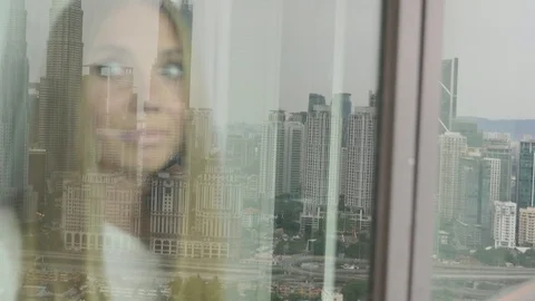 The woman Looks Through a Window | Stock Video | Pond5