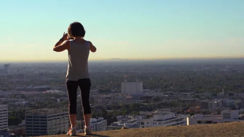 Woman at Los Angeles City lookout takes ... | Stock Video | Pond5