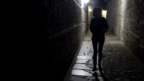 Woman model in jeans walk in dark alley ... | Stock Video | Pond5