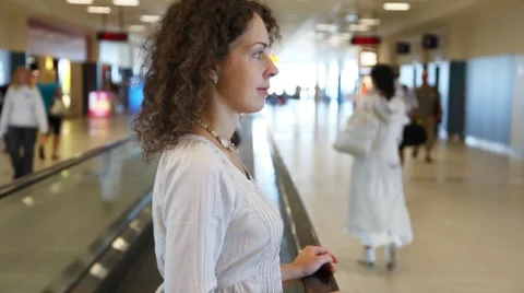 Woman moving on speedwalk at airport | Stock Video | Pond5
