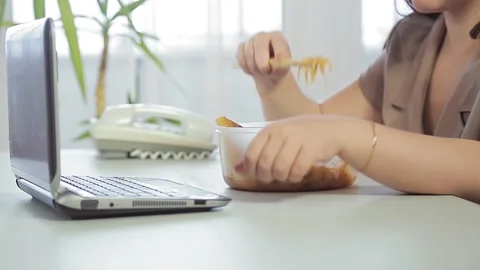 Woman office worker snacking while worki... | Stock Video | Pond5