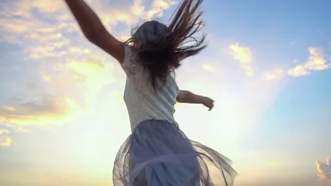 Woman open arms to the sky at sunset, Sl... | Stock Video | Pond5